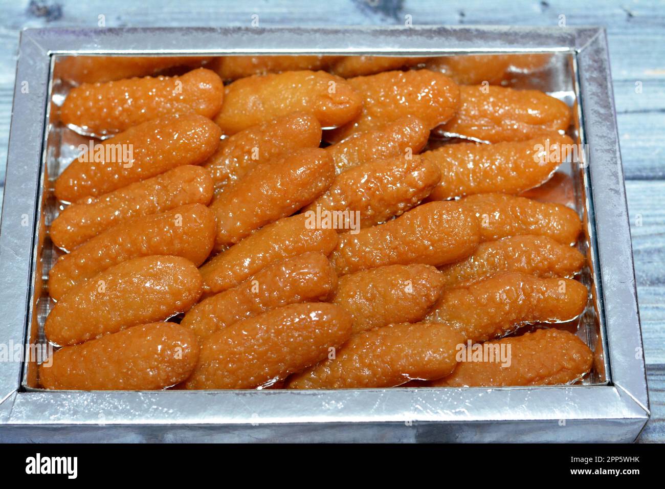 Egyptian Zainab fingers or glazed anise fingers, flour with semolina in ...