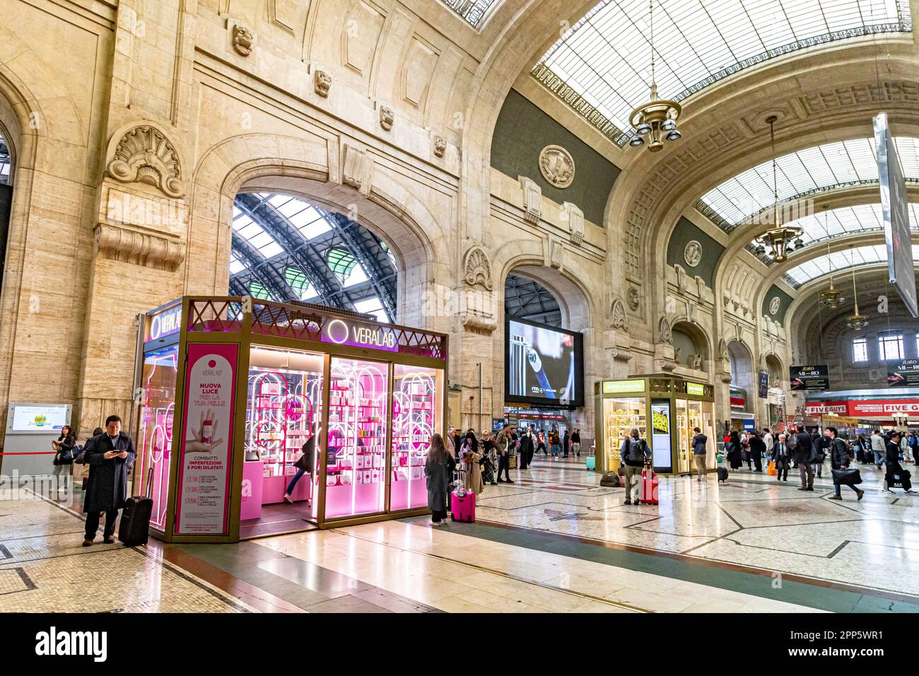 People walking through the grand interior of the main hall or galleria ...