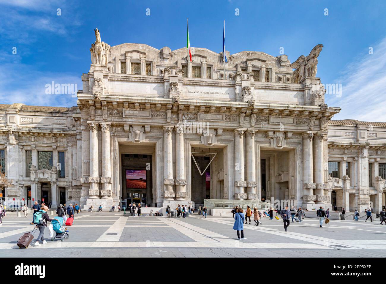 People outside the grand exterior of Milano Centrale railway station ...