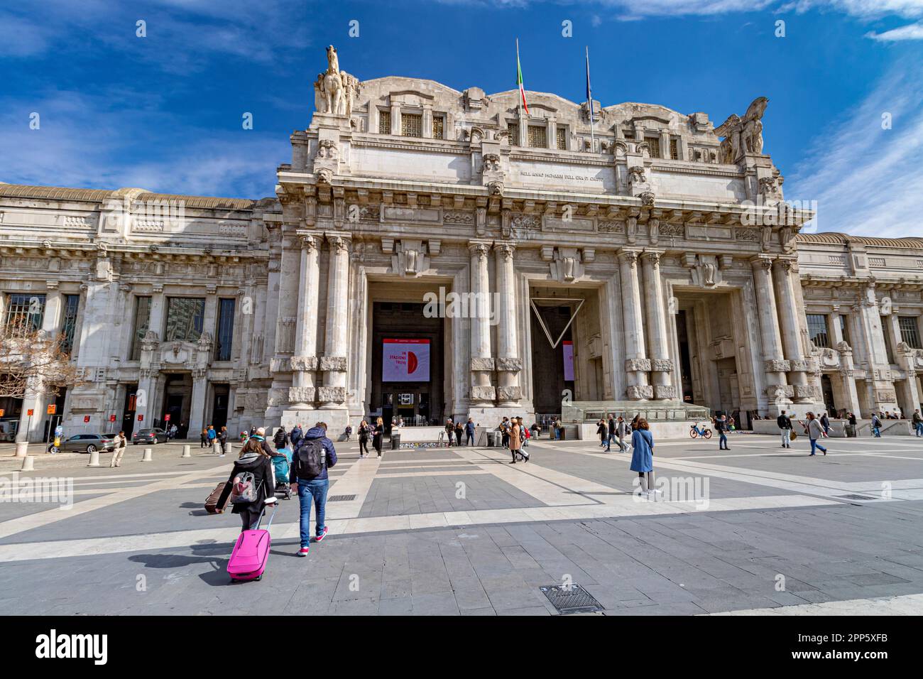 People outside the grand exterior of Milano Centrale railway station ...