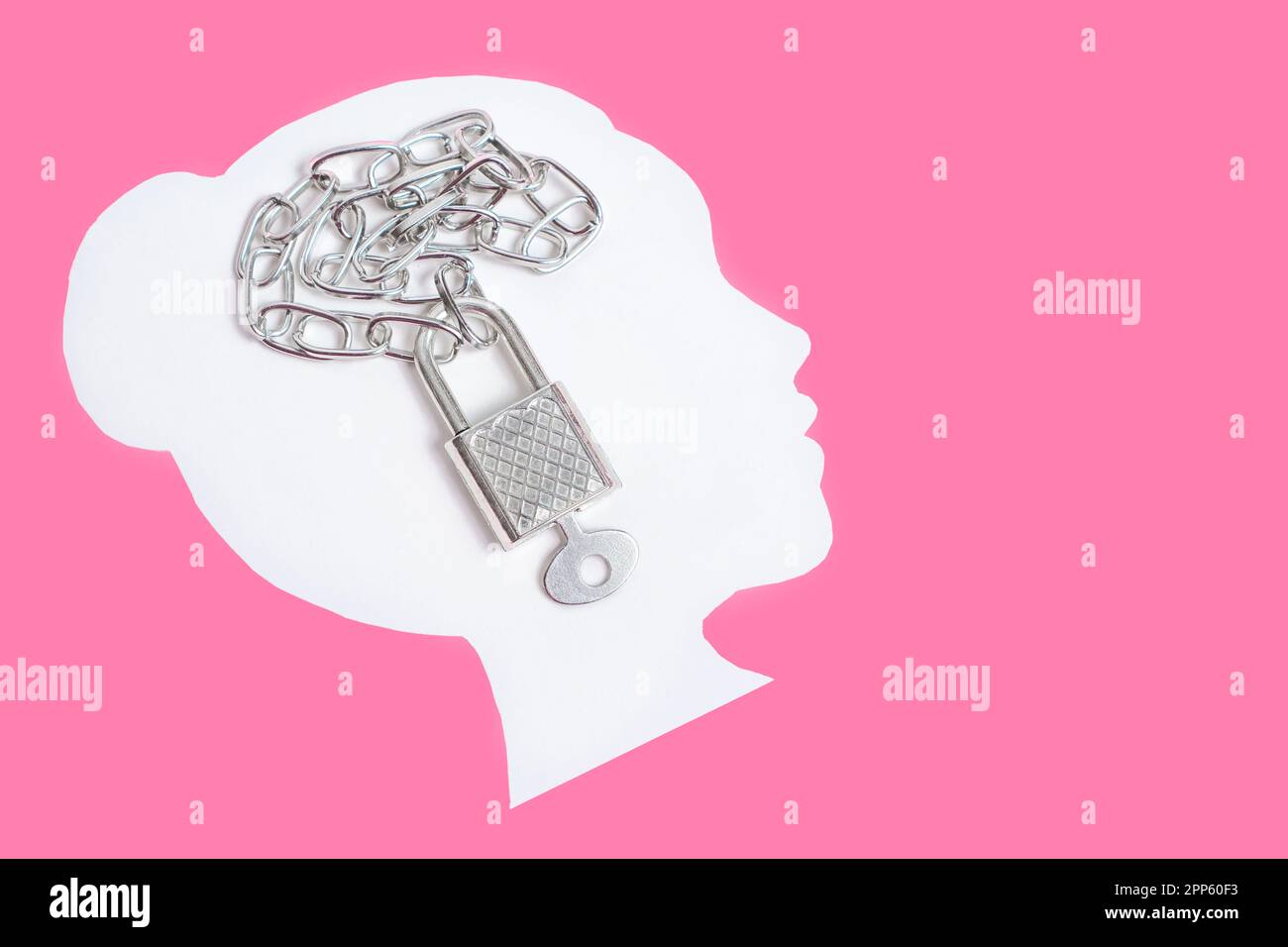 Padlock and chain placed on a white female face shape isolated on a ...