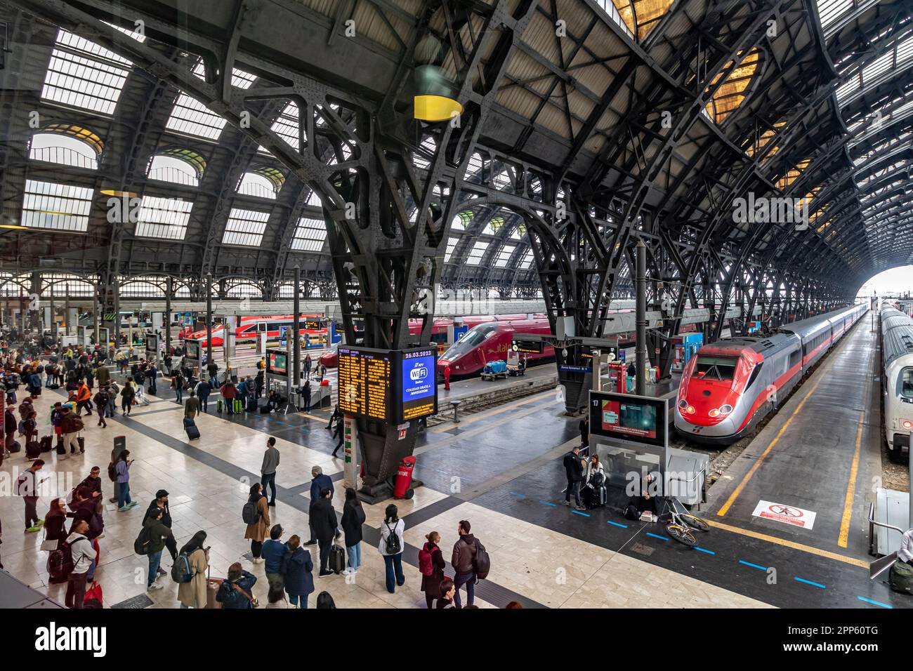 Rail passengers walking through the main concourse of Milano Centrale ...