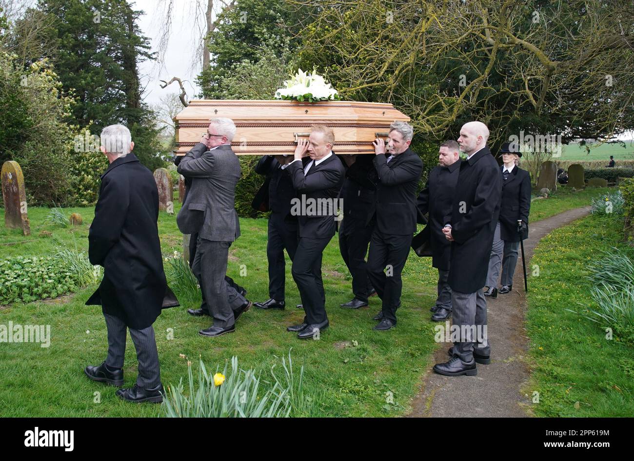 The coffin of Paul O'Grady is carried into St Rumwold's Church in Aldington, ahead of his ...