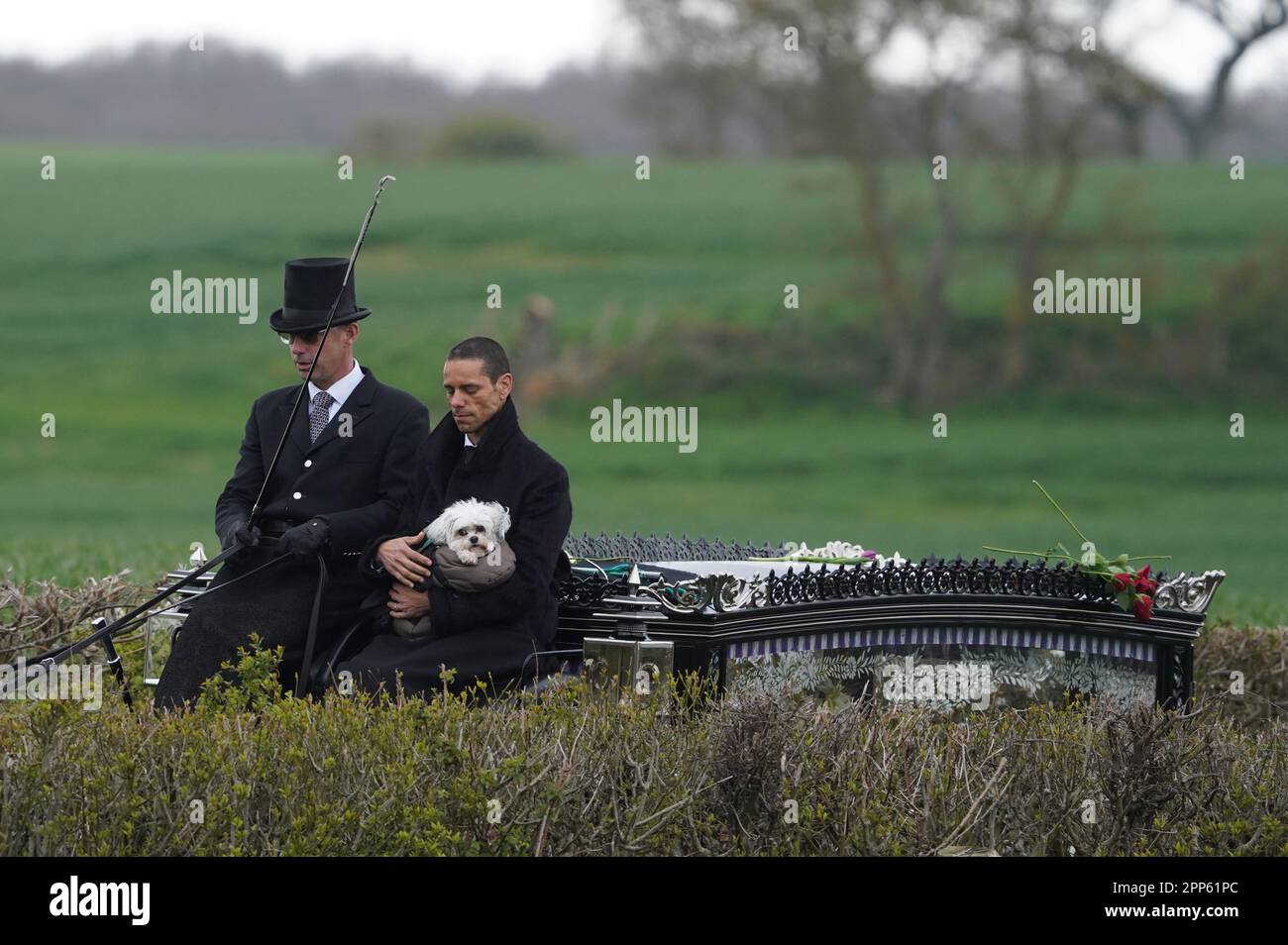 Husband of Paul O'Grady, Andre Portasio, carrying one of their dogs ...