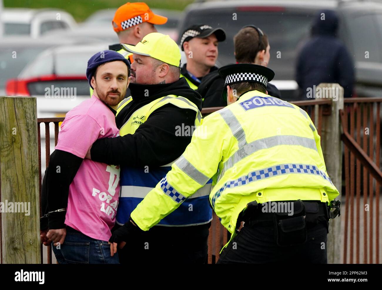 Animal Rising activists are apprehended by police officers as they ...