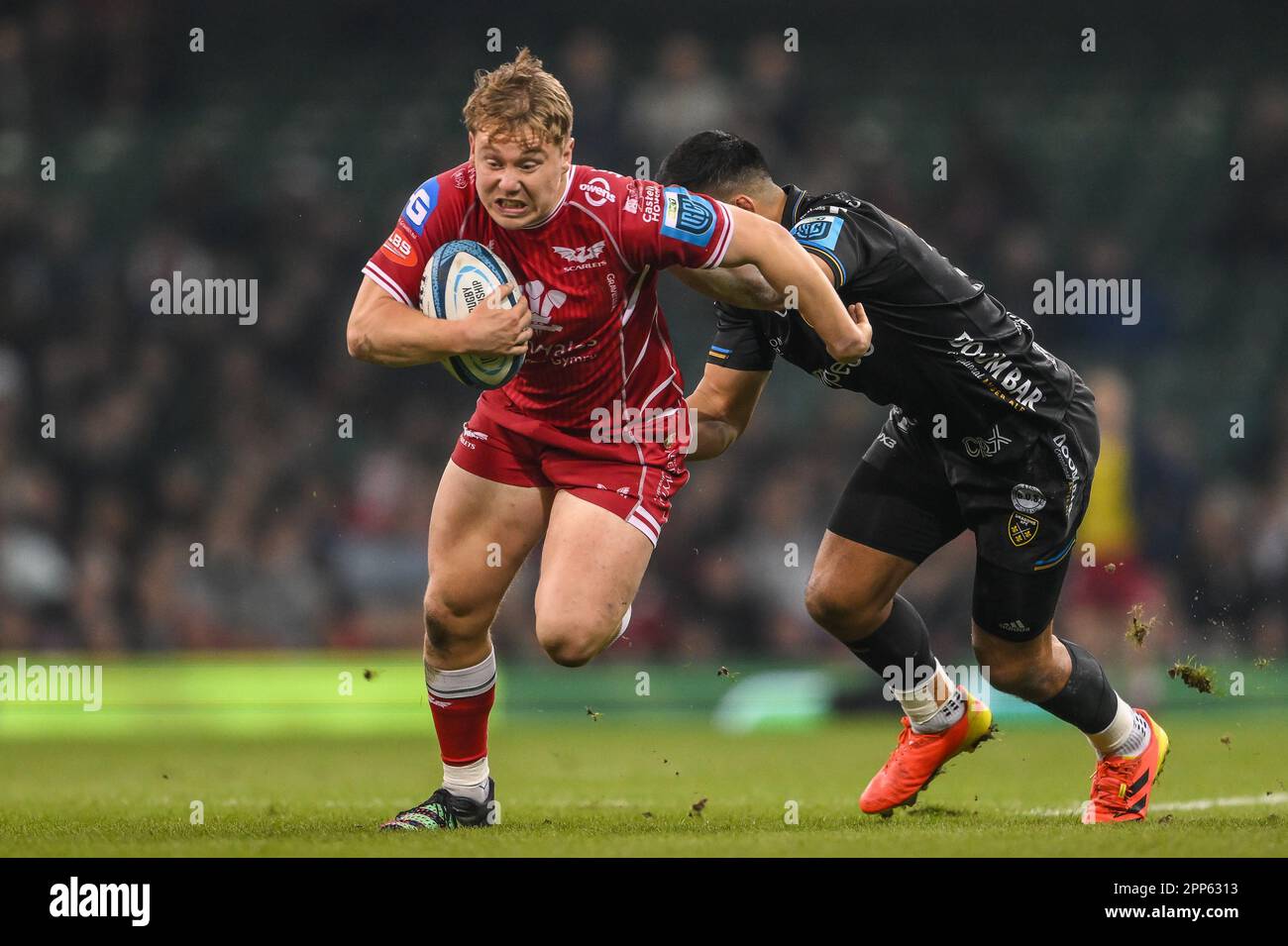 Sam Costelow of Scarlets makes a break past the tackle of Sio Tomkinson ...