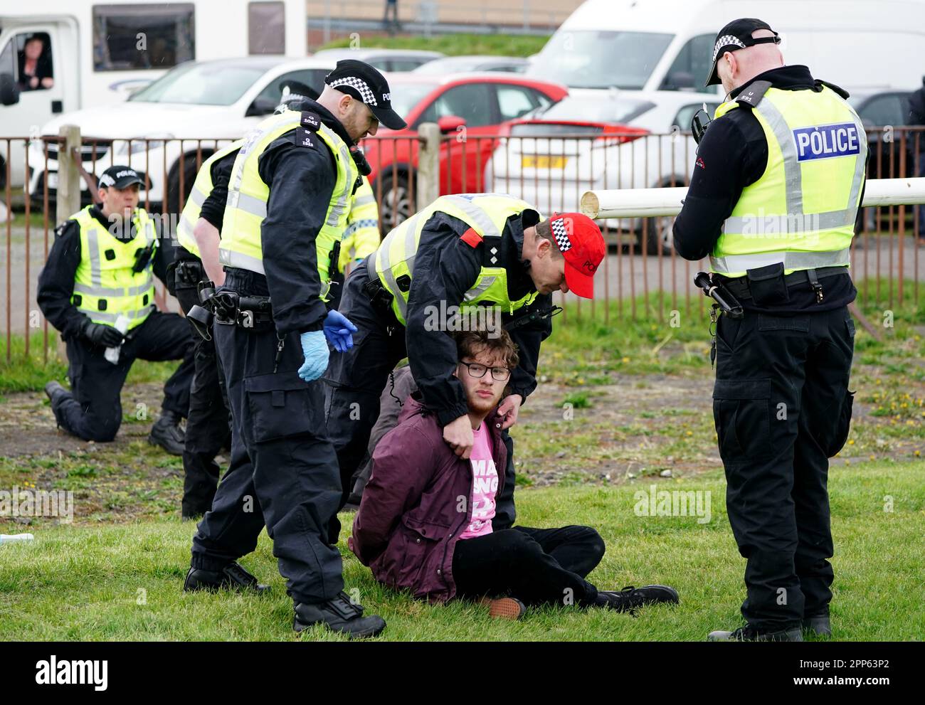 Animal Rising activists are apprehended by police officers as they ...