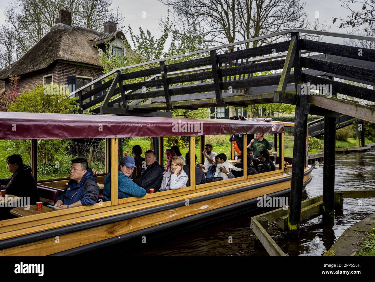 GIETHOORN - Tourists sail in a tour boat through Giethoorn during the ...