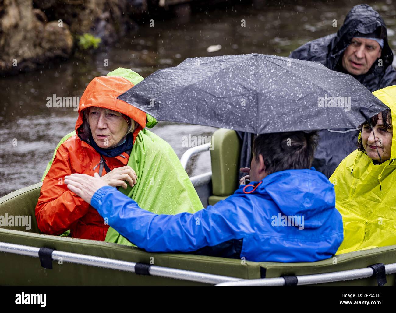 GIETHOORN - Tourists sail in a boat through the rain in Giethoorn ...