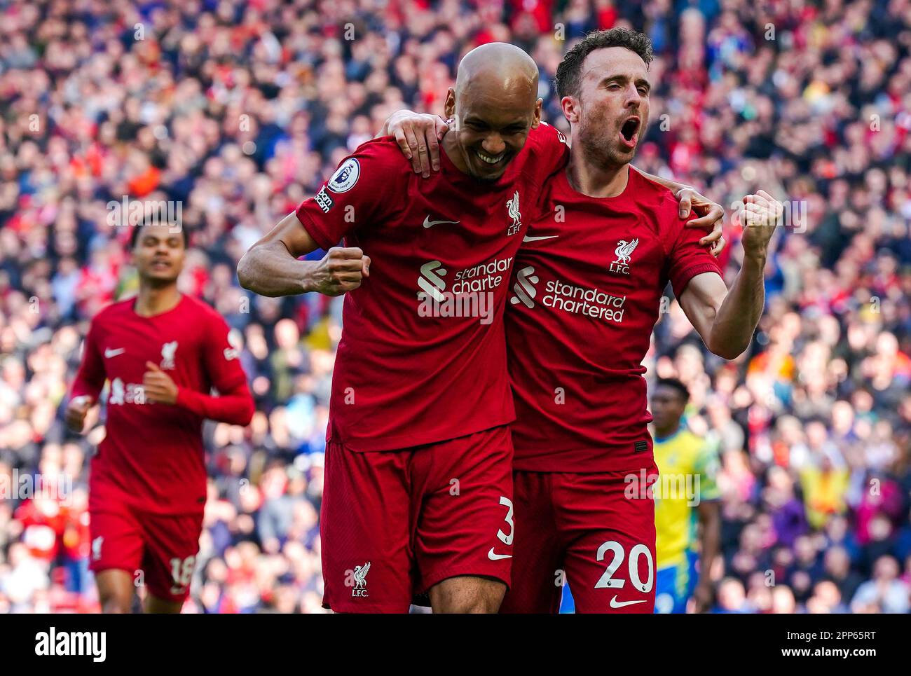 Liverpool's Diogo Jota (right) celebrates scoring the opening goal with ...