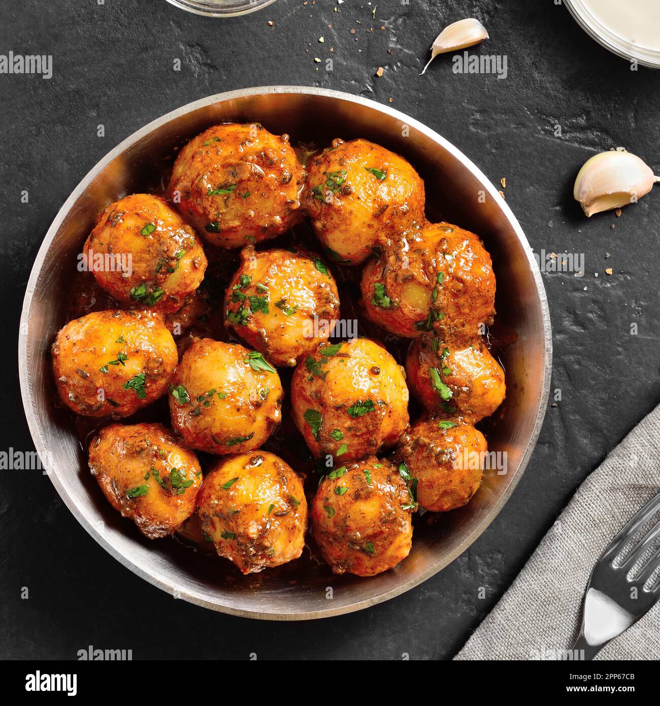 Pan fried little baby potatoes with jeera seeds and coriander in bowl ...