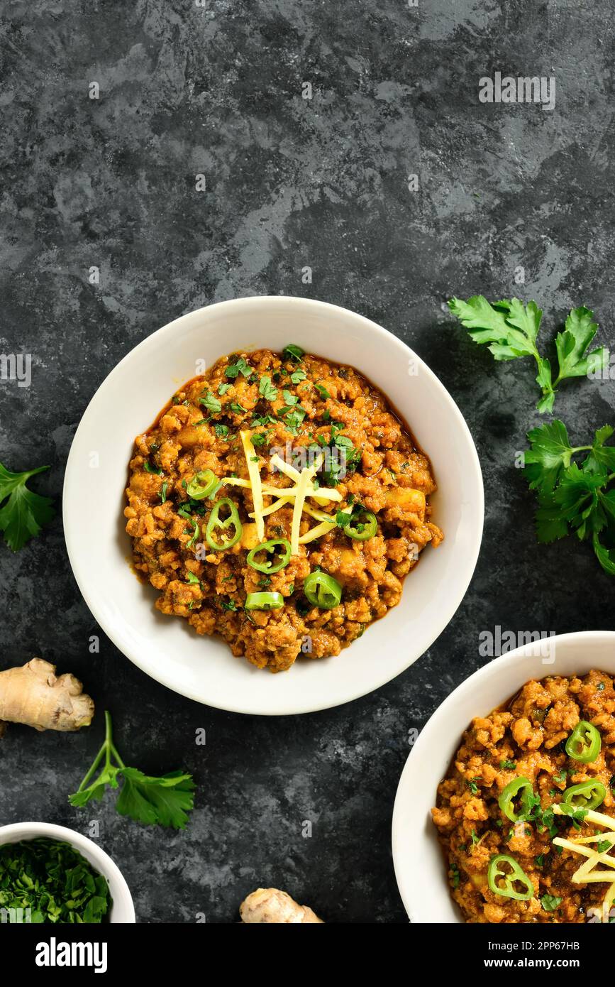Keema curry in bowl over dark stone background. Indian and pakistani ...