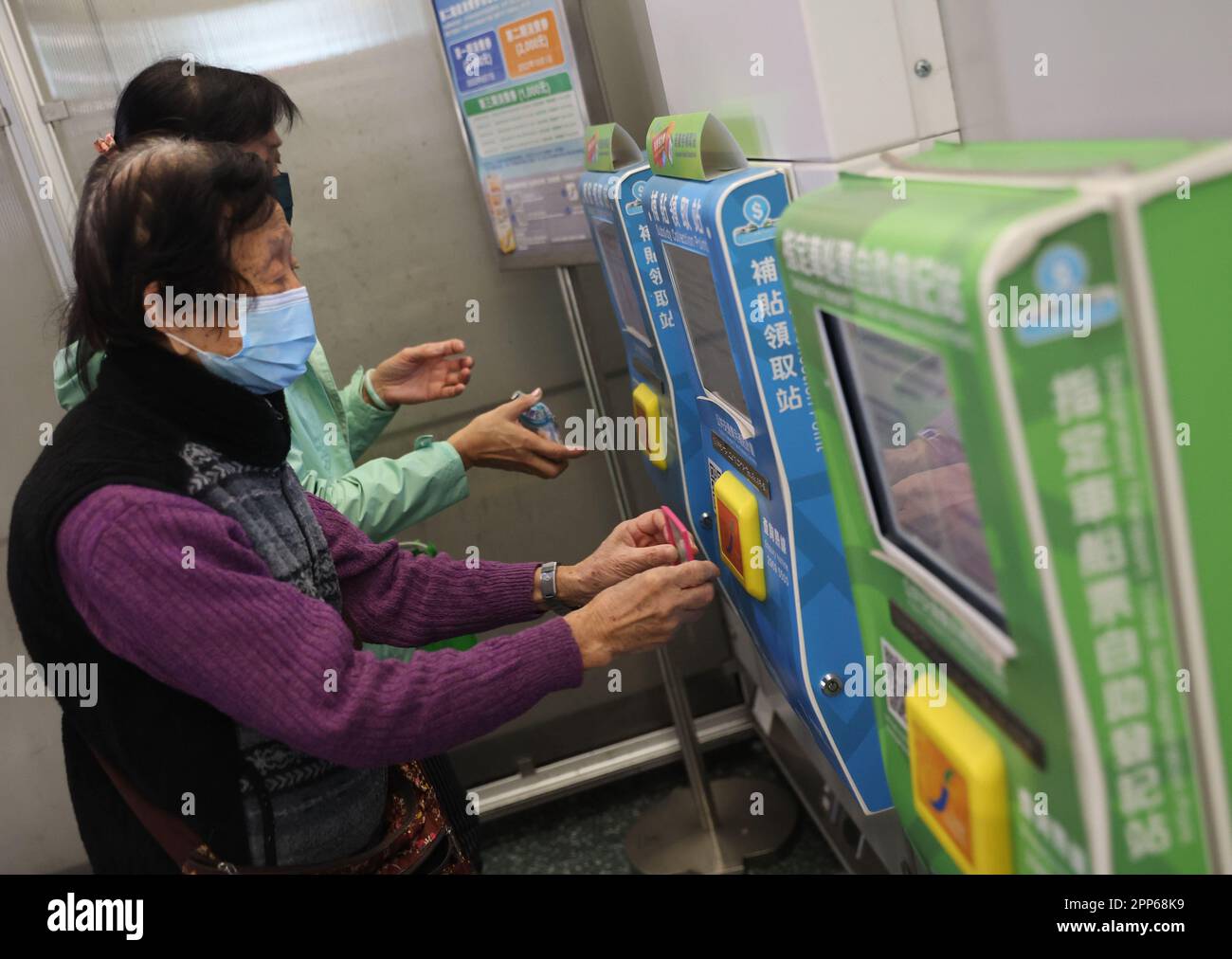 People line up to collect their last batch of consumption vouchers in ...