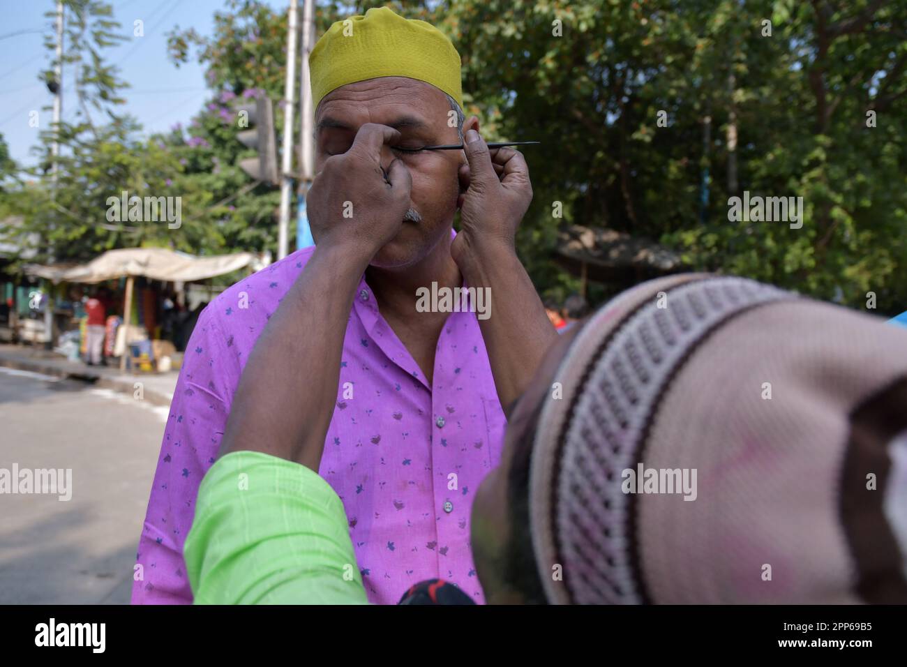 A Muslim man seen applying Surma on eyes before the special prayers on ...