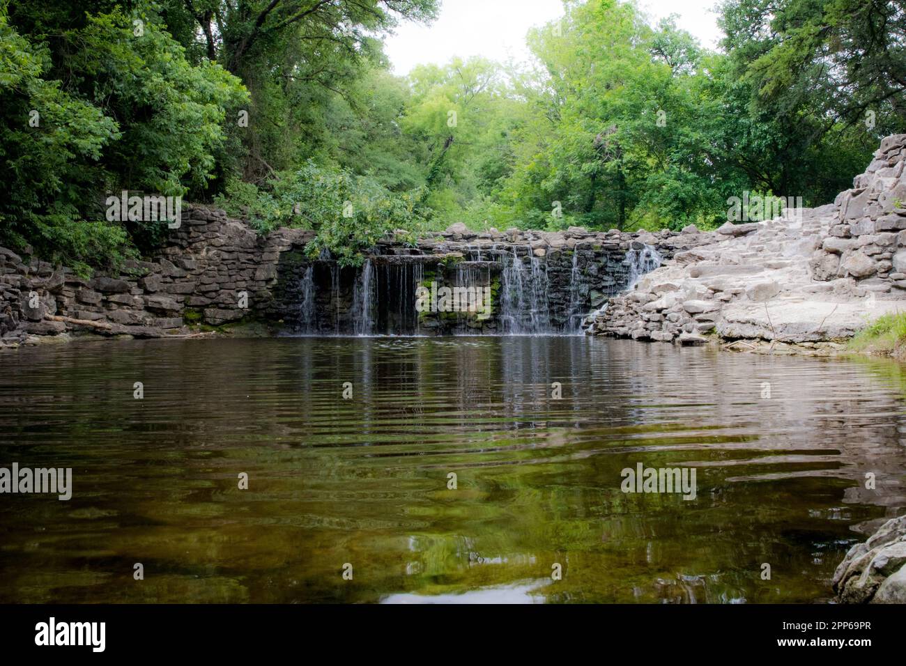 A stunning image of a tranquil cascading waterfall spilling into a ...