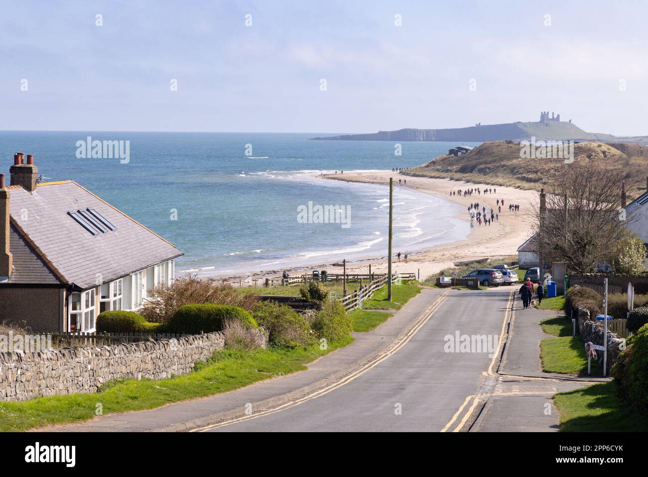 Northumberland beach; people walking along the beach from Low Newton by ...