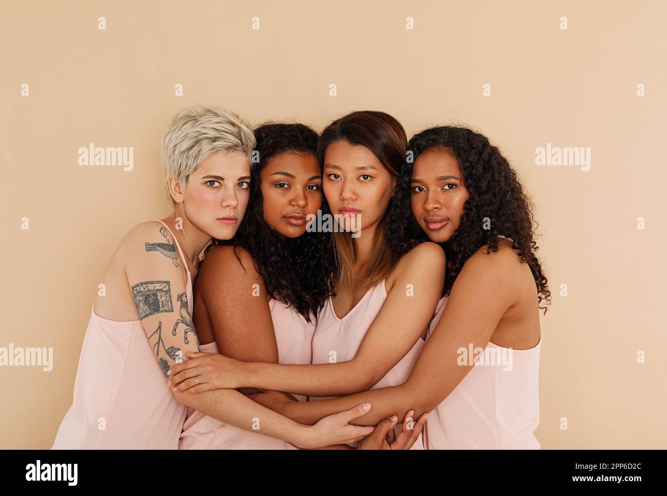 Four different women embracing each other. Young females posing ... Four different women embracing each other. Young females posing ...