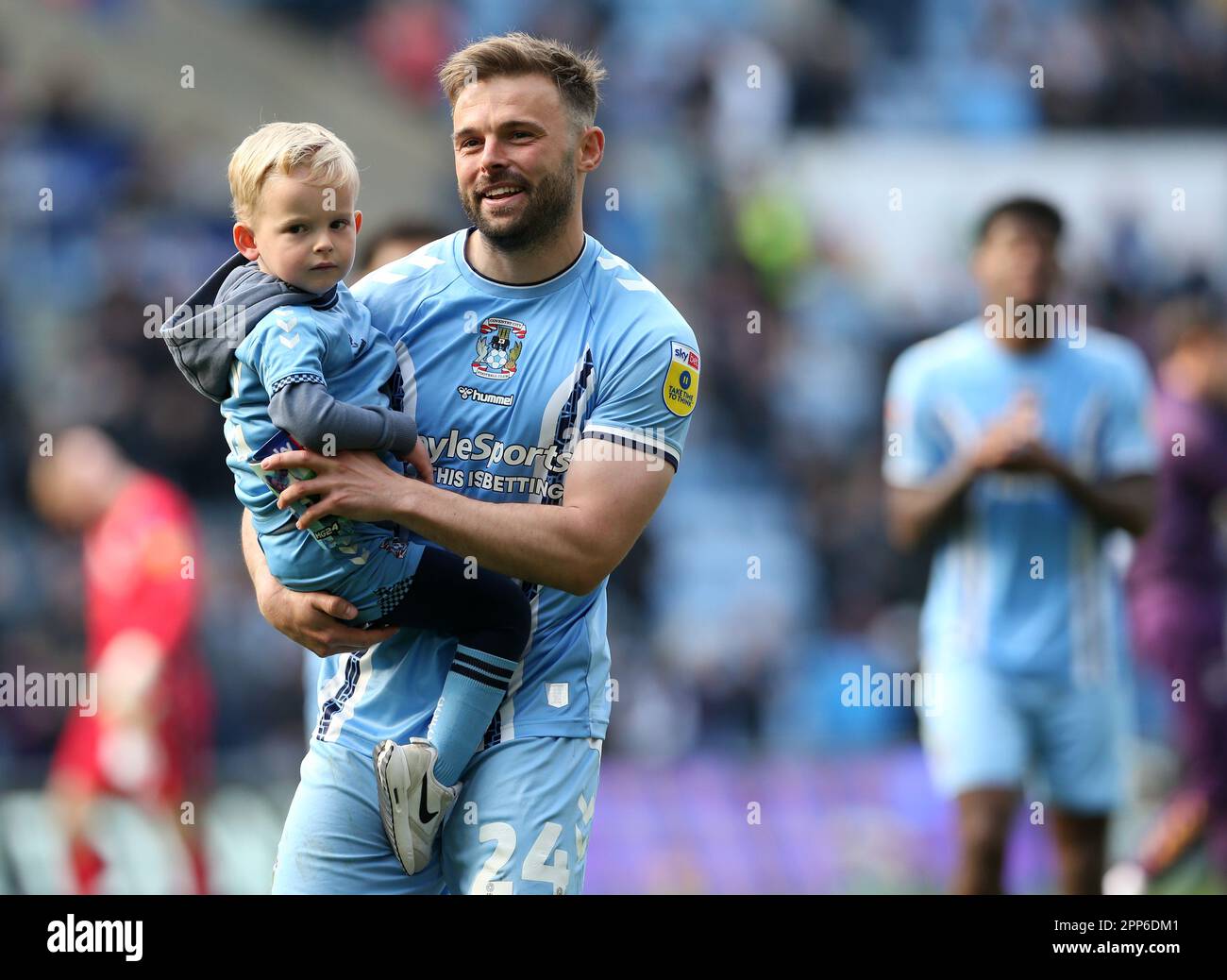 Coventry City's Matthew Godden celebrates on the pitch with his son ...