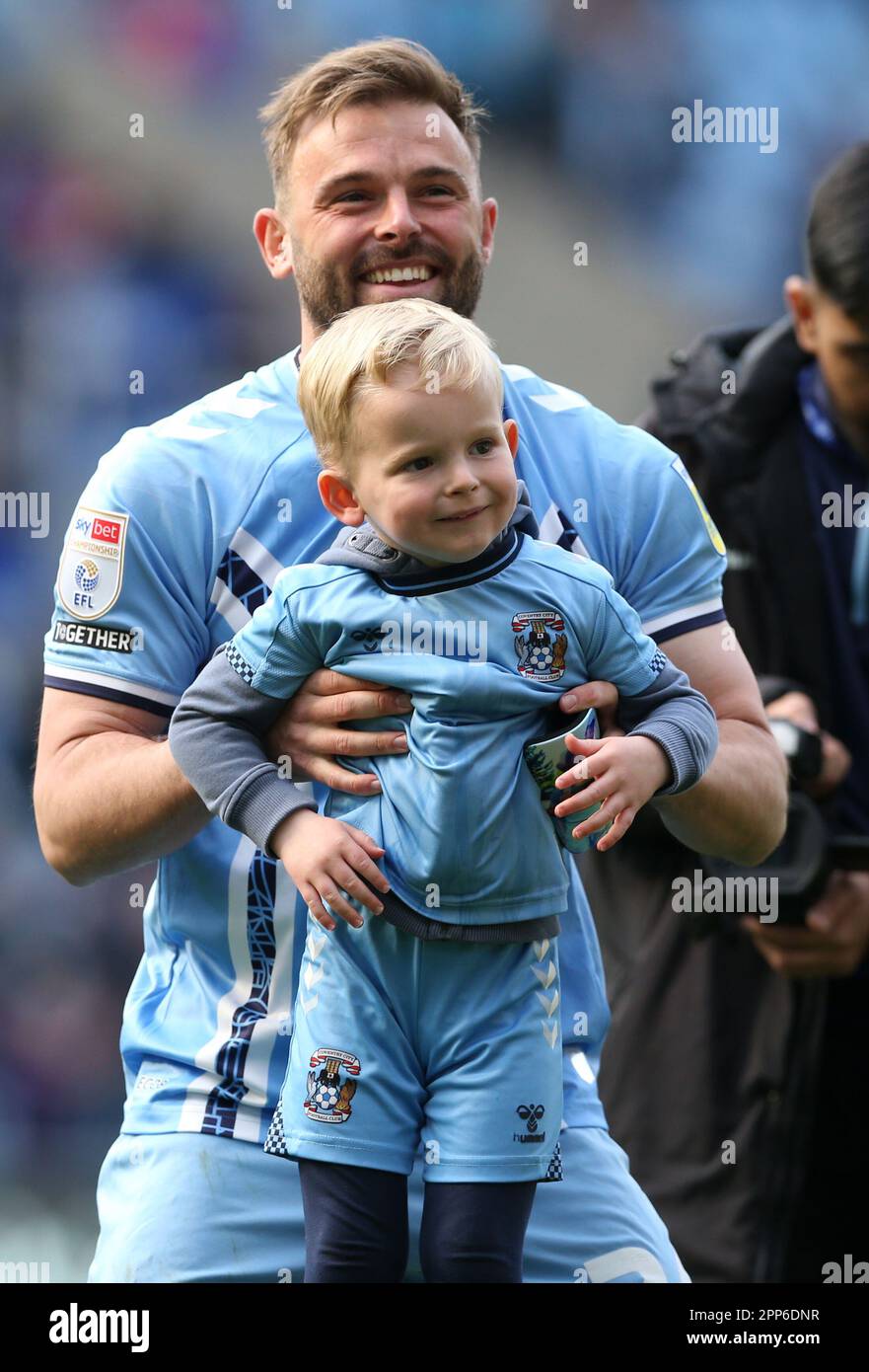 Coventry City's Matthew Godden celebrates on the pitch with his son ...