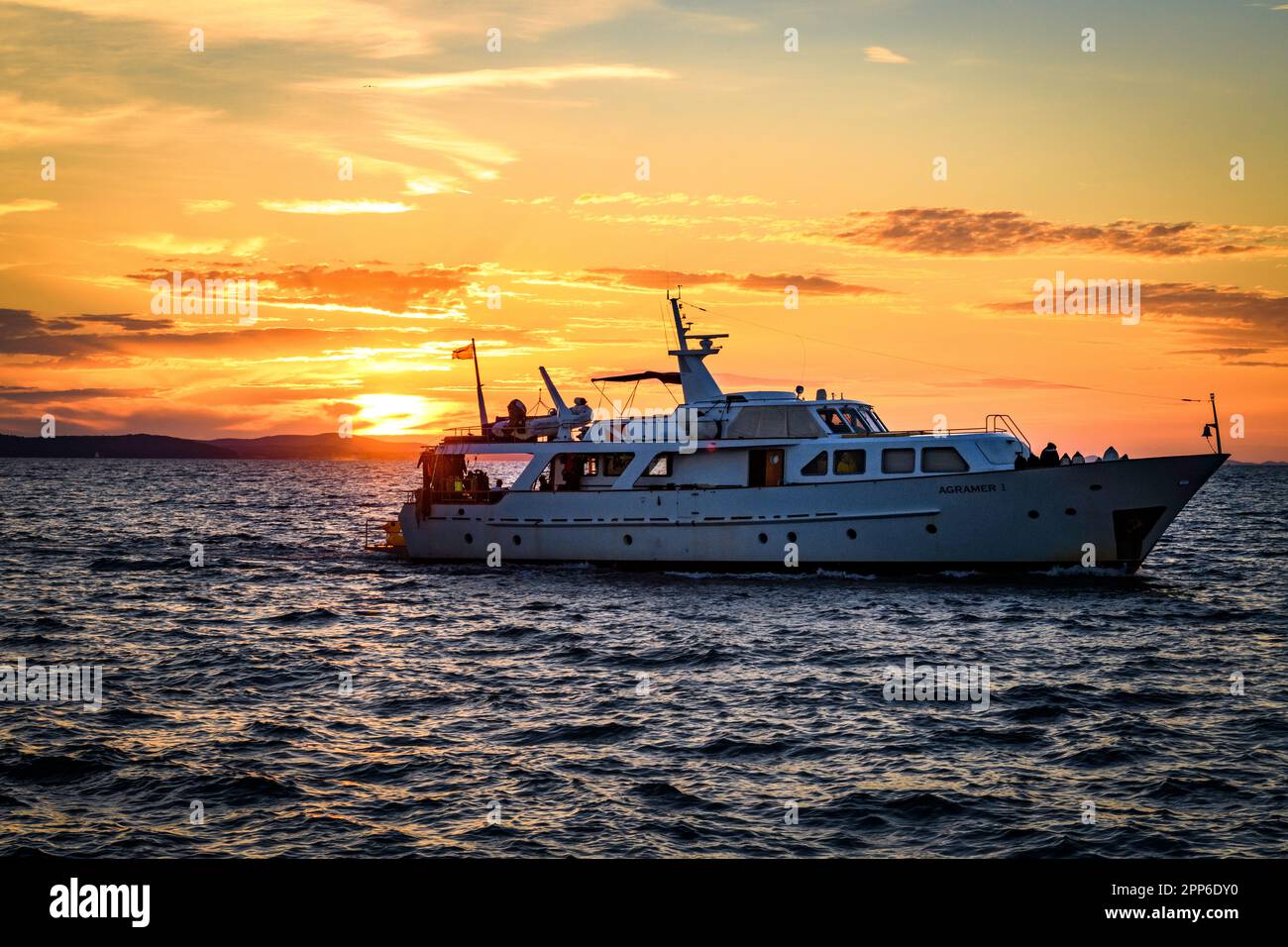 A vessel is pictured against a backdrop of a beautiful sunset on the ...