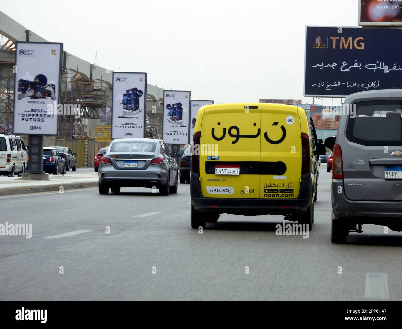 Giza, Egypt, April 9 2023: Noon online shopping delivery yellow van to ...