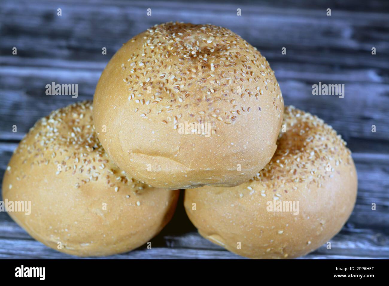 Round hand sized hamburger burger bun baked and covered with sesame ...