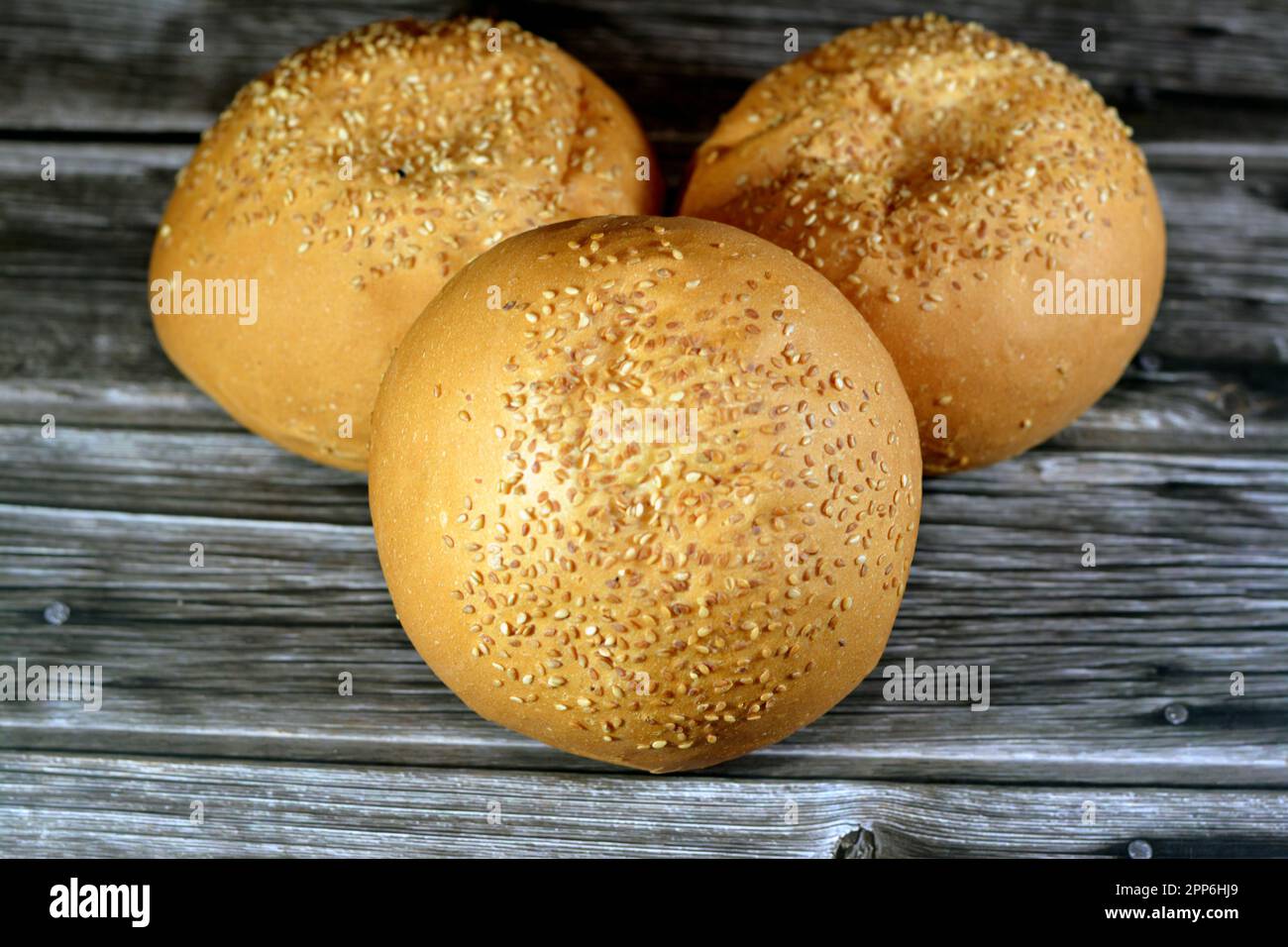 Round hand sized hamburger burger bun baked and covered with sesame ...