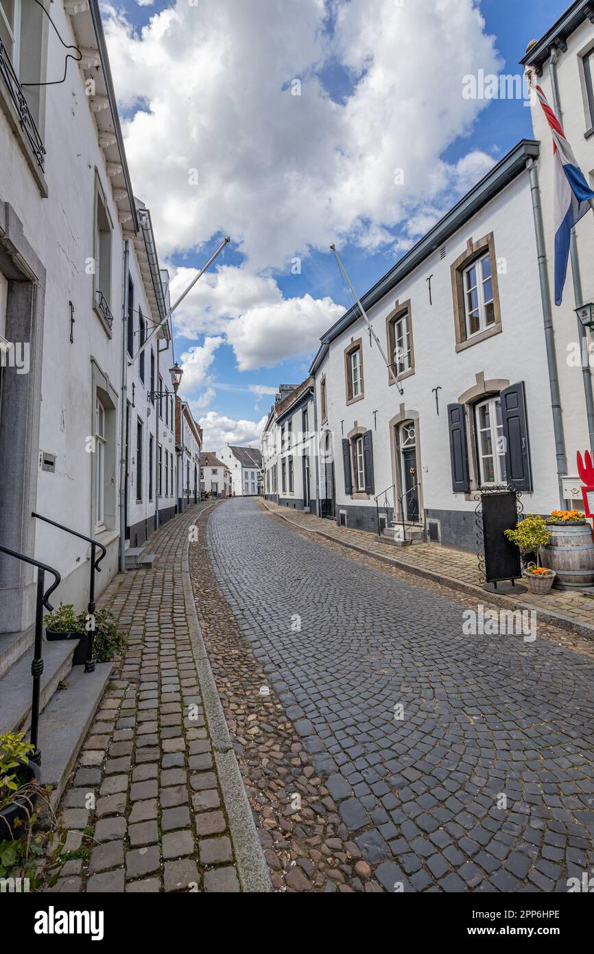 Urban landscape of a narrow cobbled street and sidewalks between ...