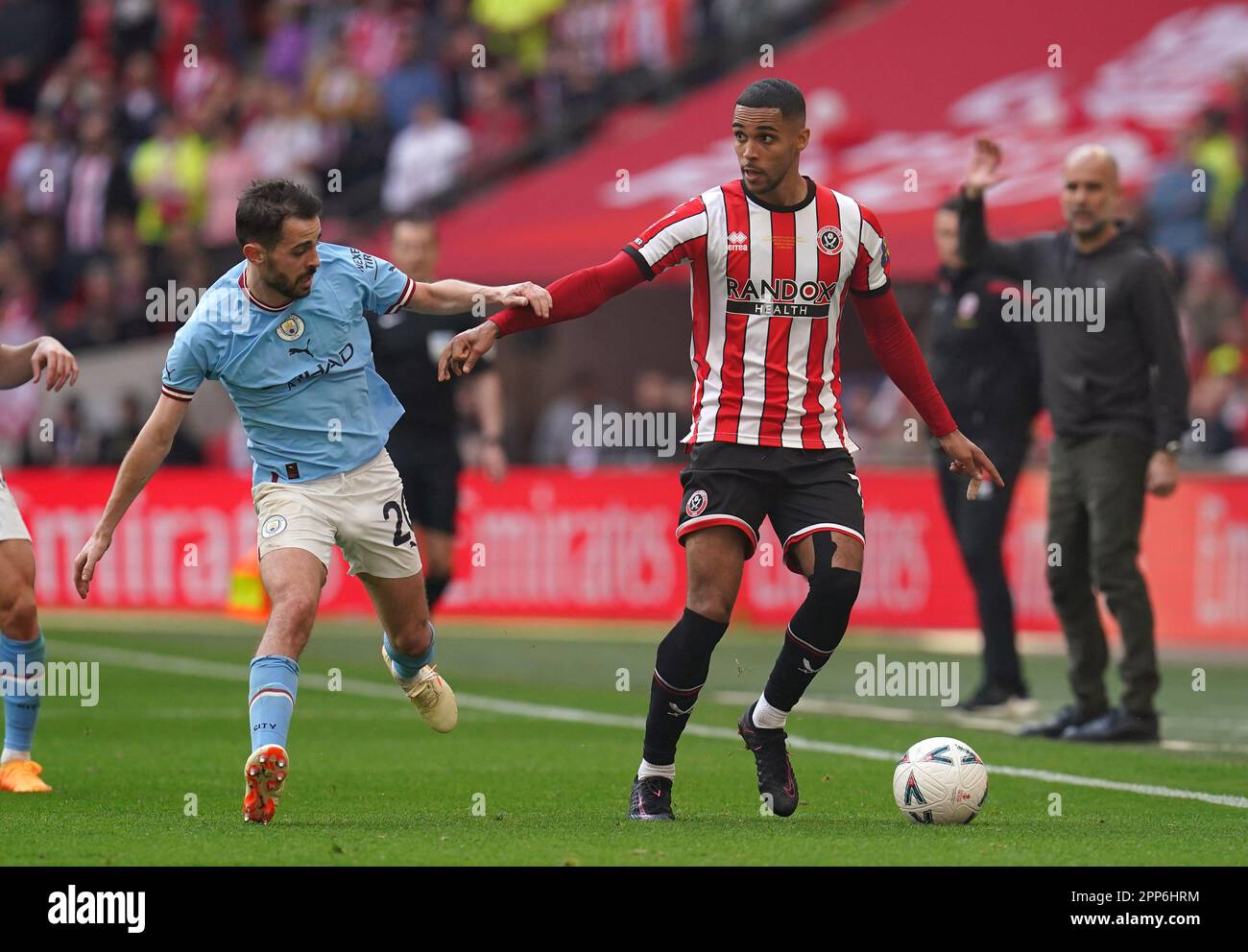 Manchester City's Bernardo Silva (left) and Sheffield United's Max Lowe ...