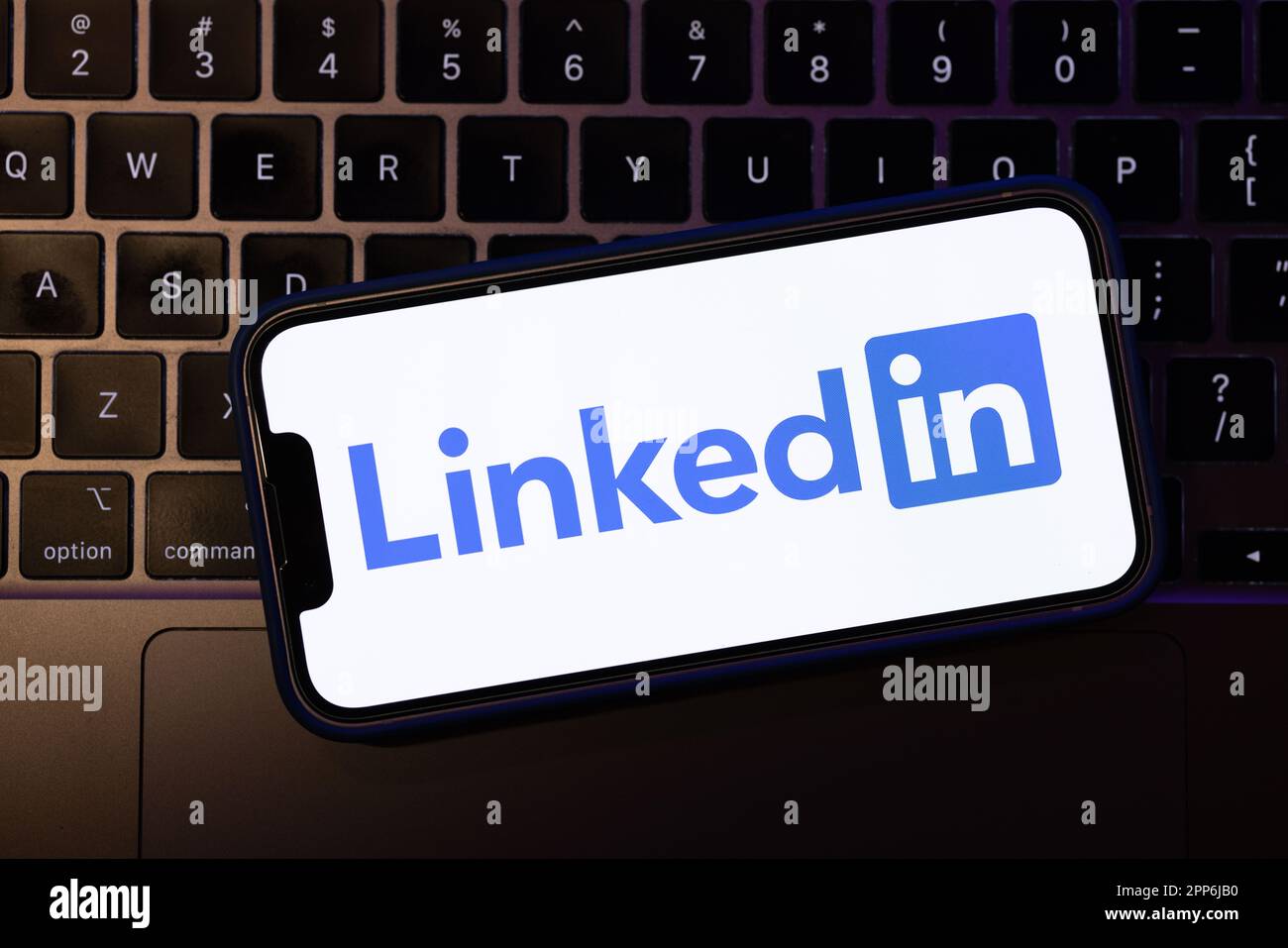 In this photo illustration a Linkedin logo seen displayed on a mobile ...