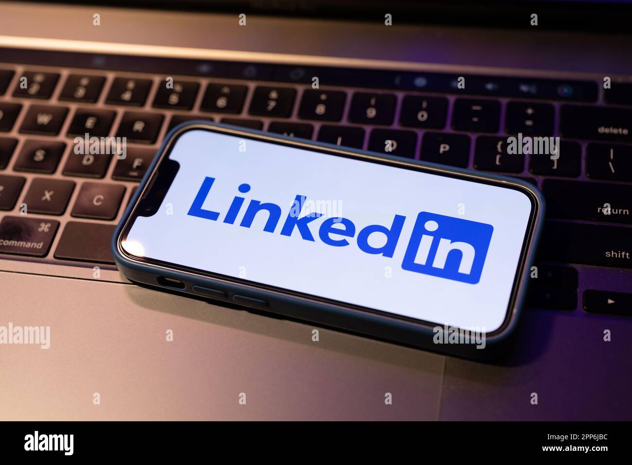 In this photo illustration a Linkedin logo seen displayed on a mobile ...
