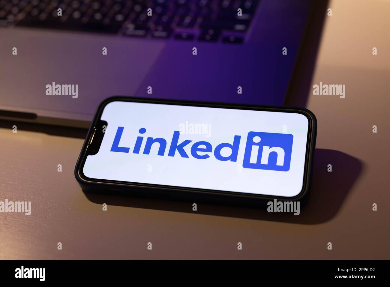 In this photo illustration a Linkedin logo seen displayed on a mobile ...