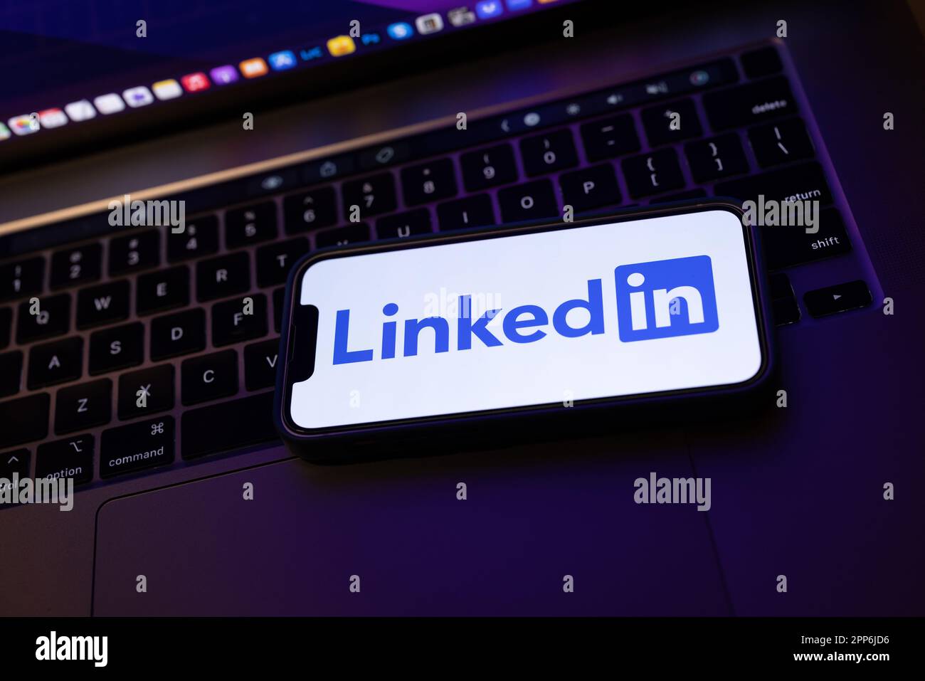 In this photo illustration a Linkedin logo seen displayed on a mobile ...