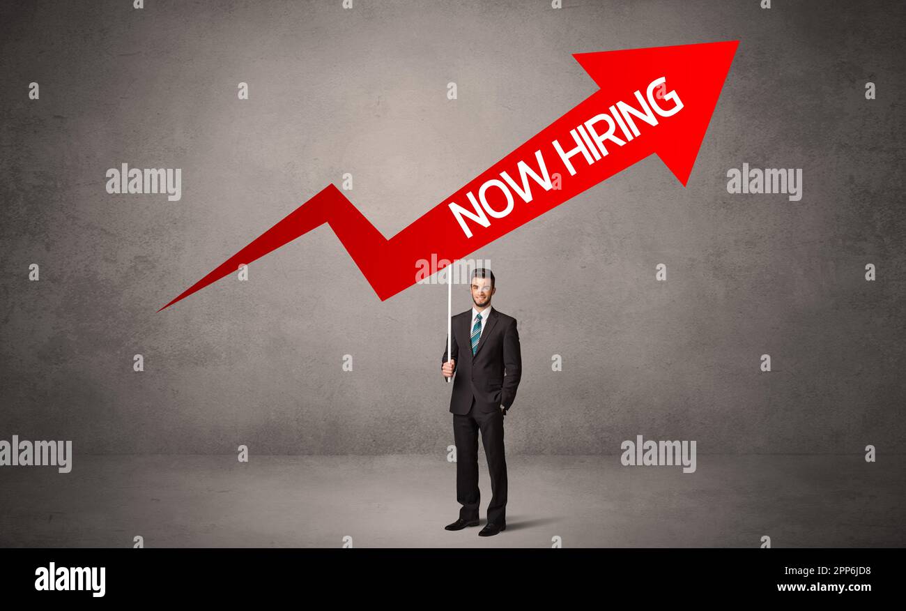 Young business person in casual holding road sign Stock Photo - Alamy