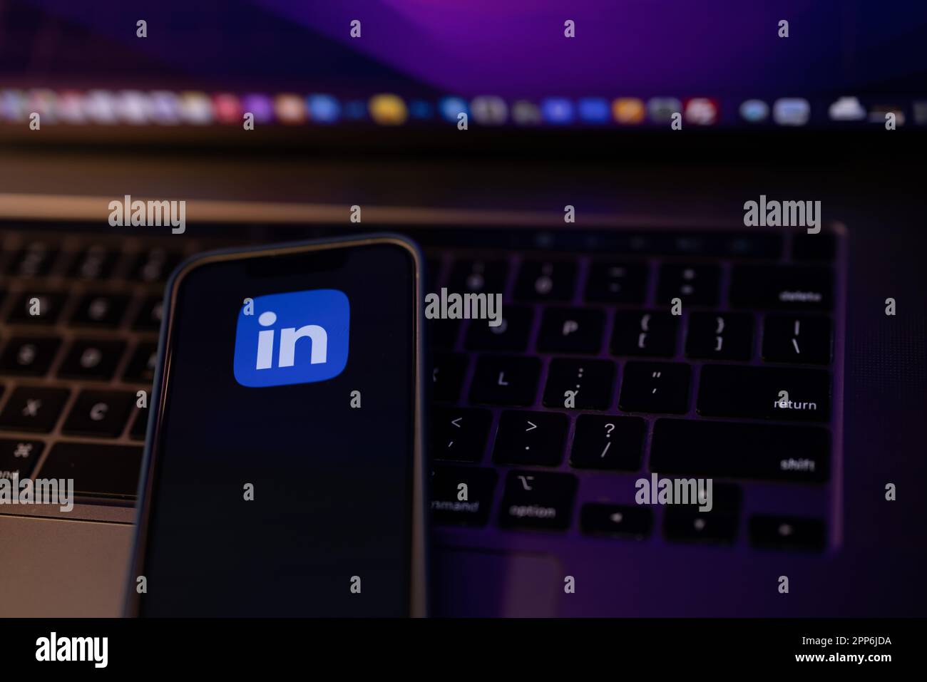 In this photo illustration a Linkedin logo seen displayed on a mobile ...