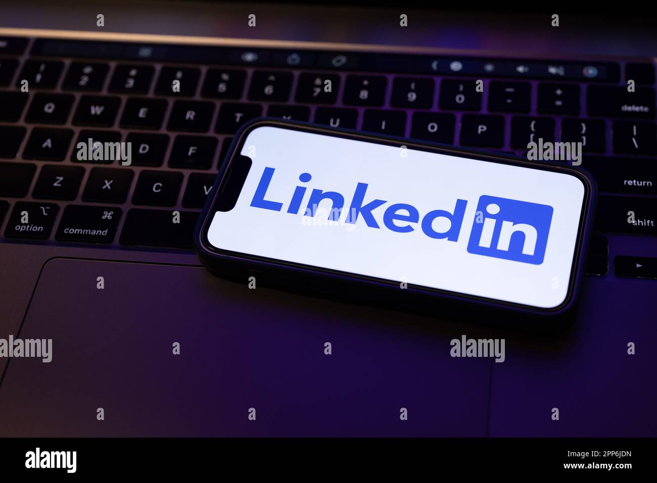 In this photo illustration a Linkedin logo seen displayed on a mobile ...