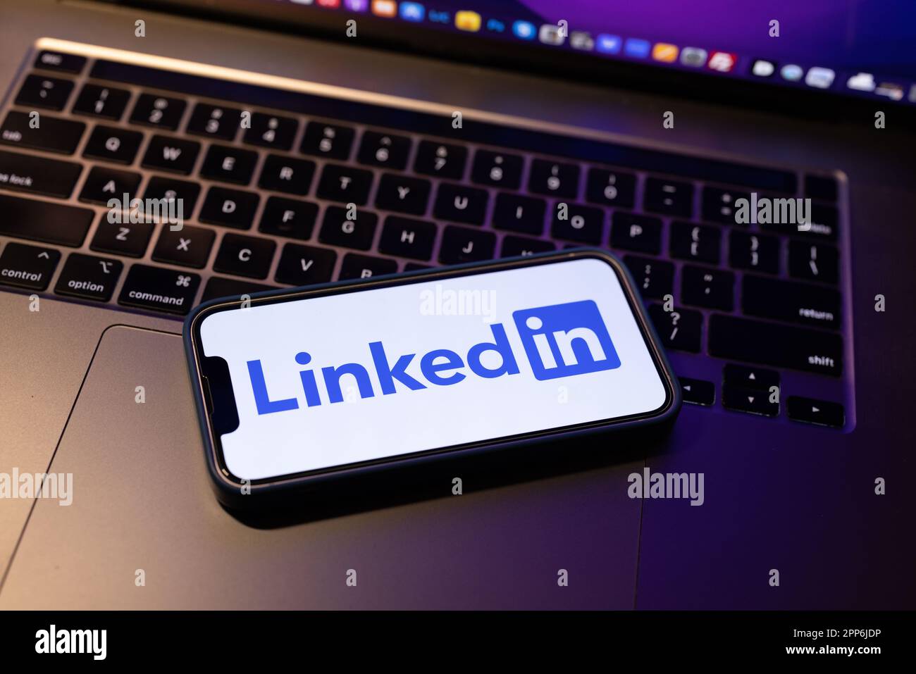 In this photo illustration a Linkedin logo seen displayed on a mobile ...