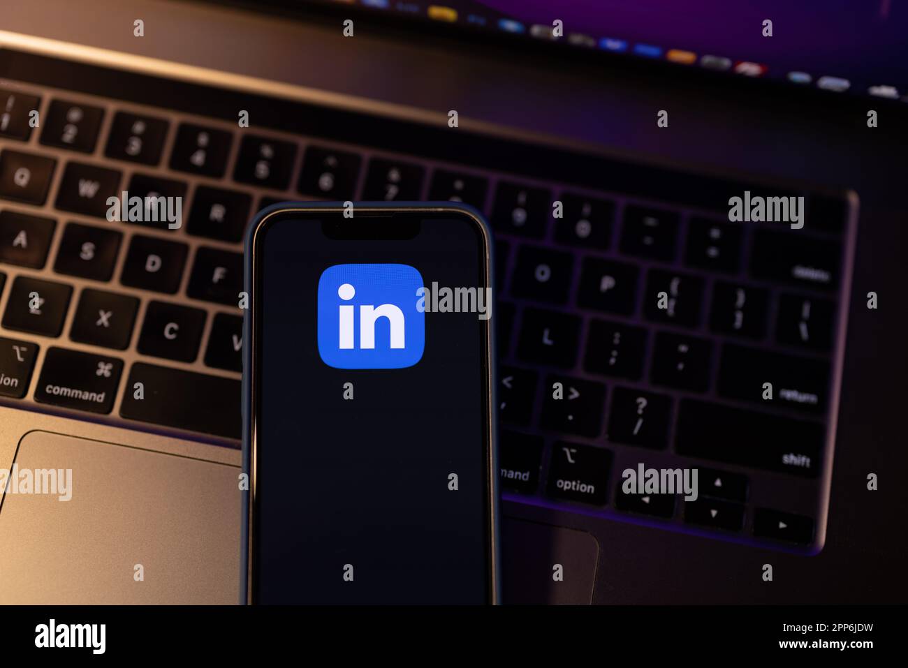 In this photo illustration a Linkedin logo seen displayed on a mobile ...