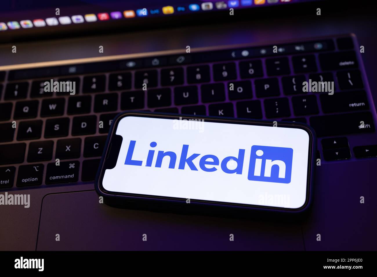 In this photo illustration a Linkedin logo seen displayed on a mobile ...