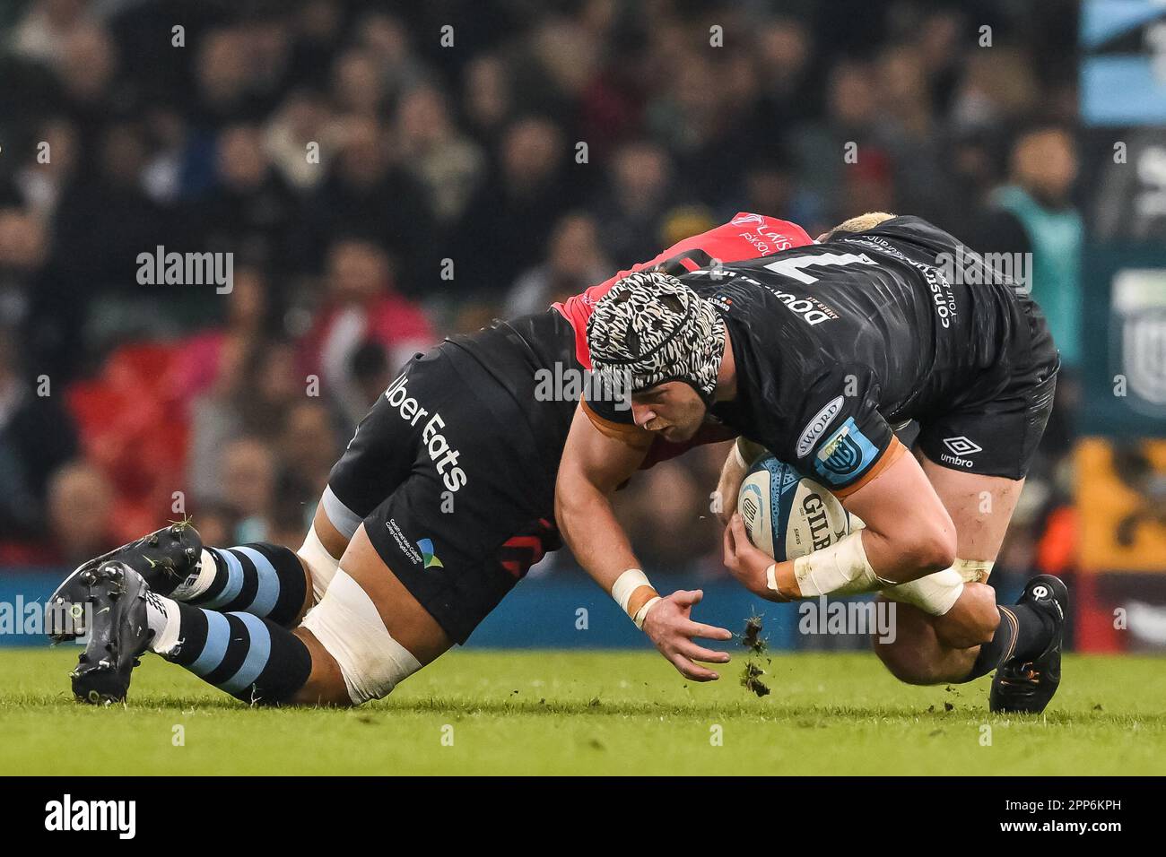 Dan Lydiate of Ospreys is tackled by Taulupe Faletau of Cardiff during ...