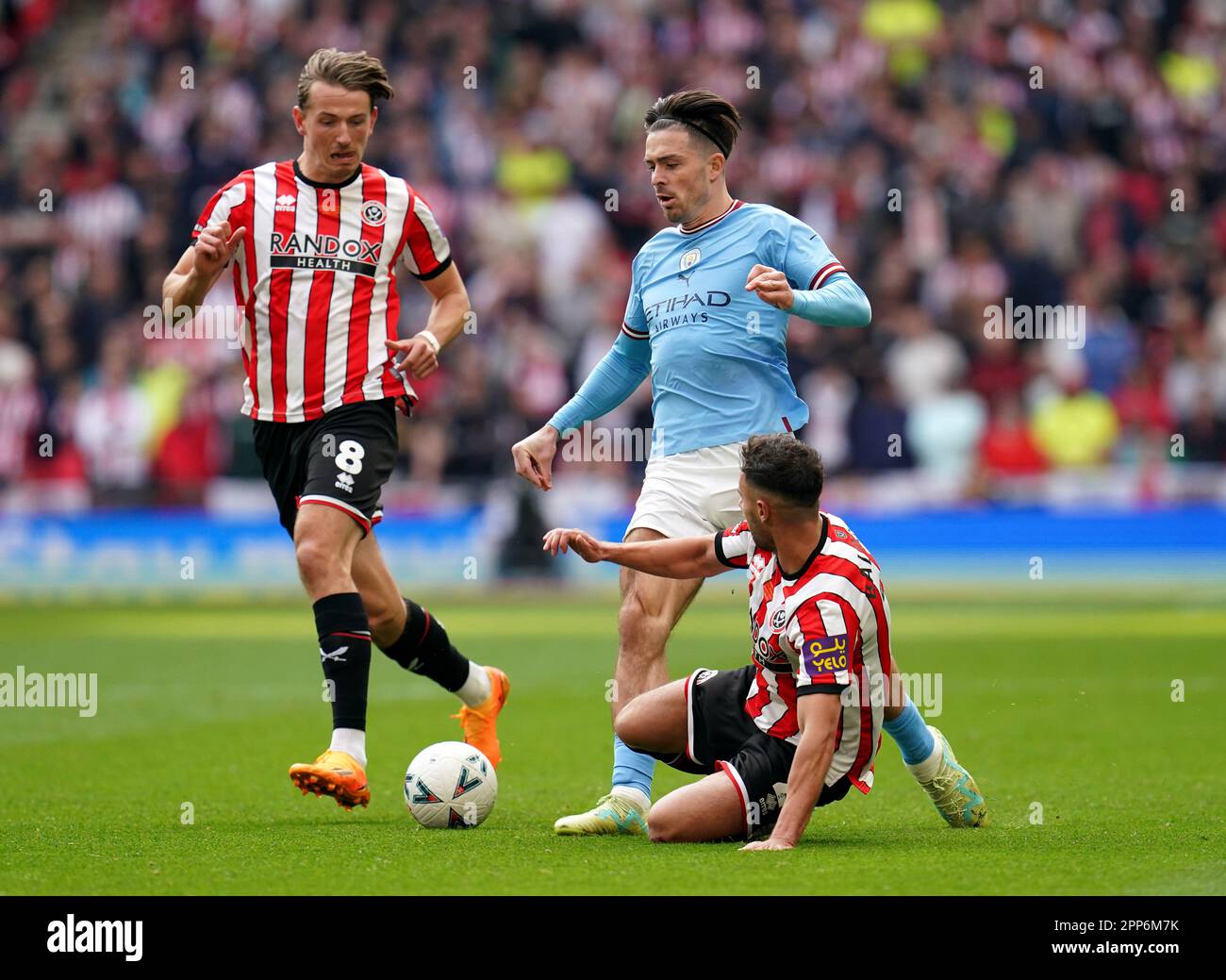 Manchester City's Jack Grealish is tackled by Sheffield United's George ...