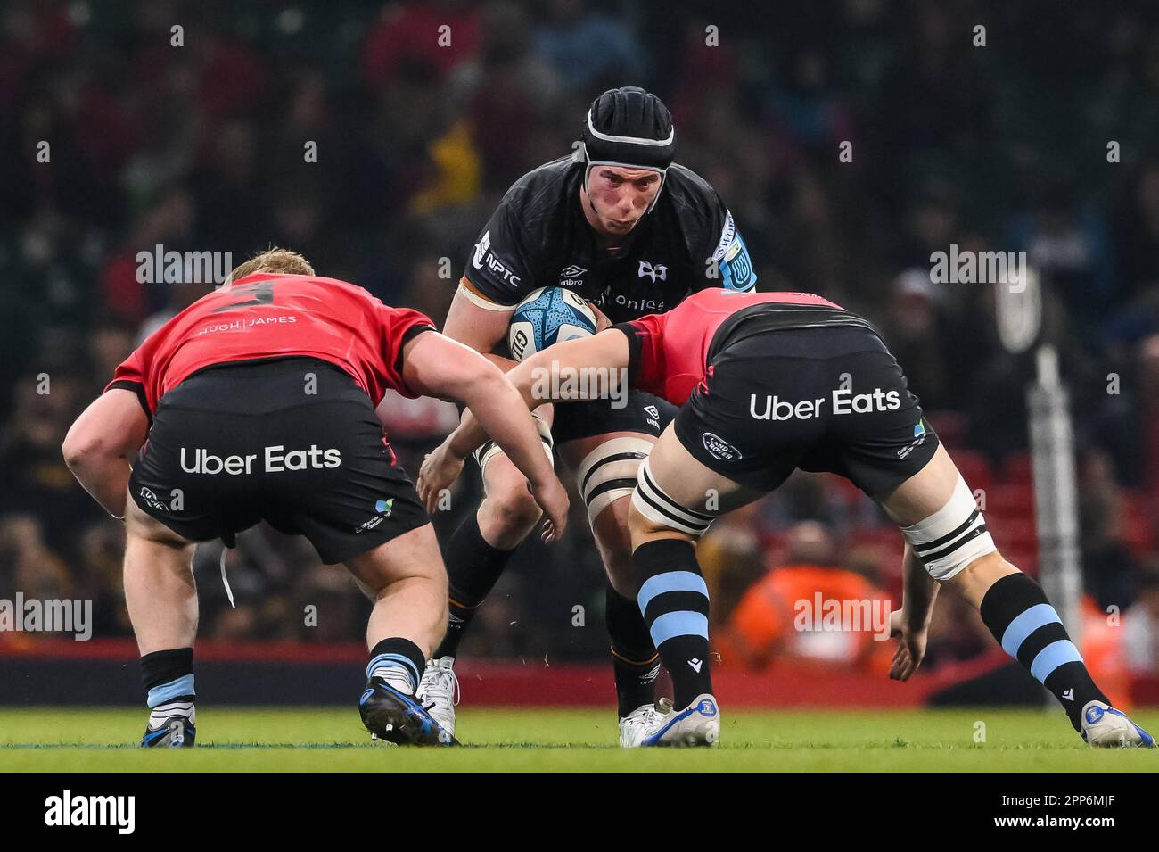 Adam Beard of Ospreys is tackled by Keiron Assiratti and James Botham ...