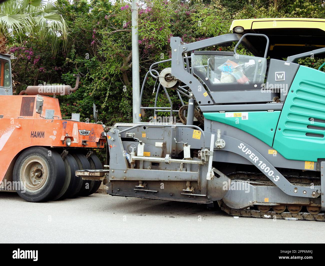 Cairo, Egypt, April 8 2023: Asphalt paver trucks and compactors, A ...