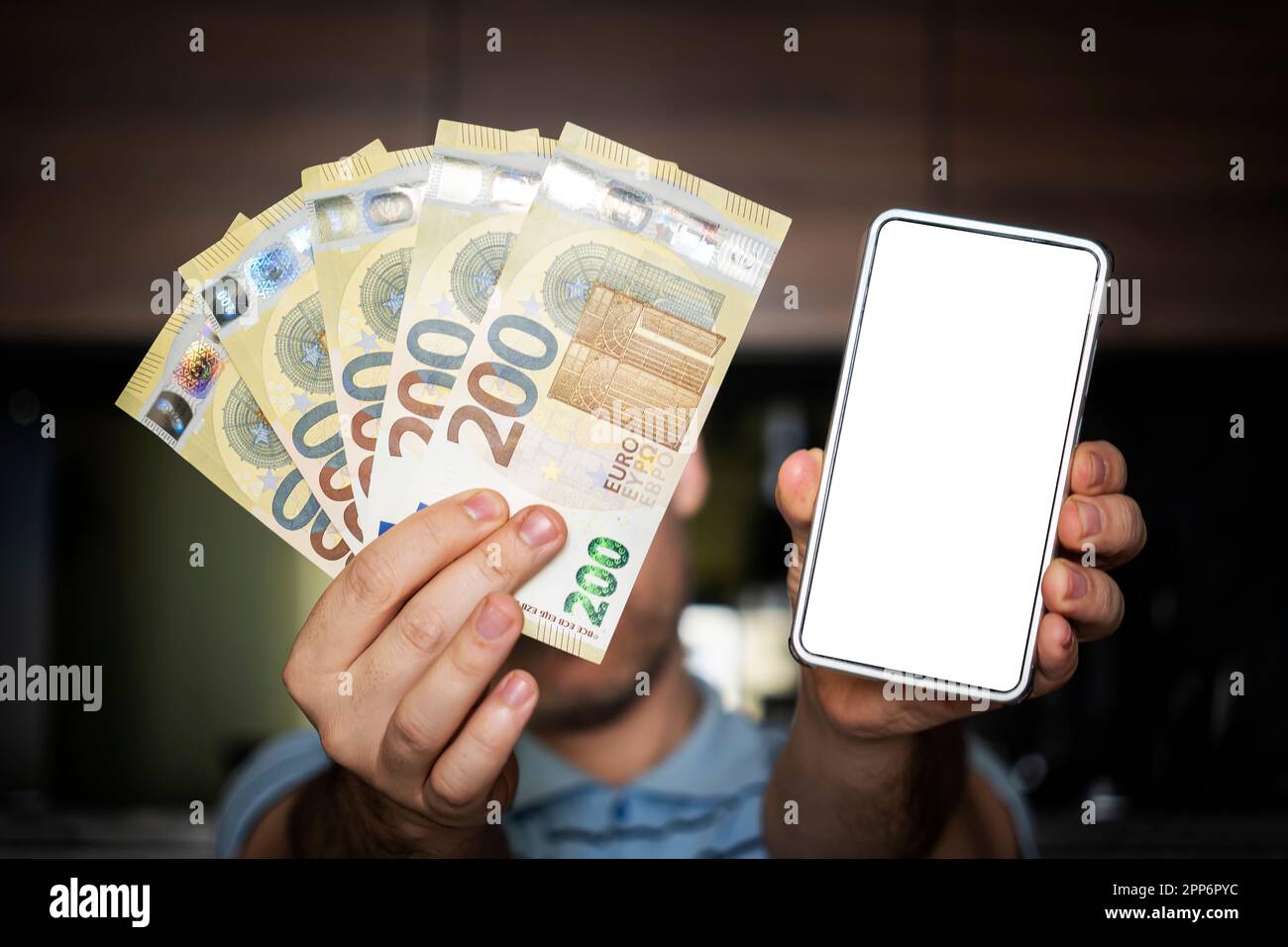 man wears casual clothes blue shirt in hand fan of cash money in euro ...