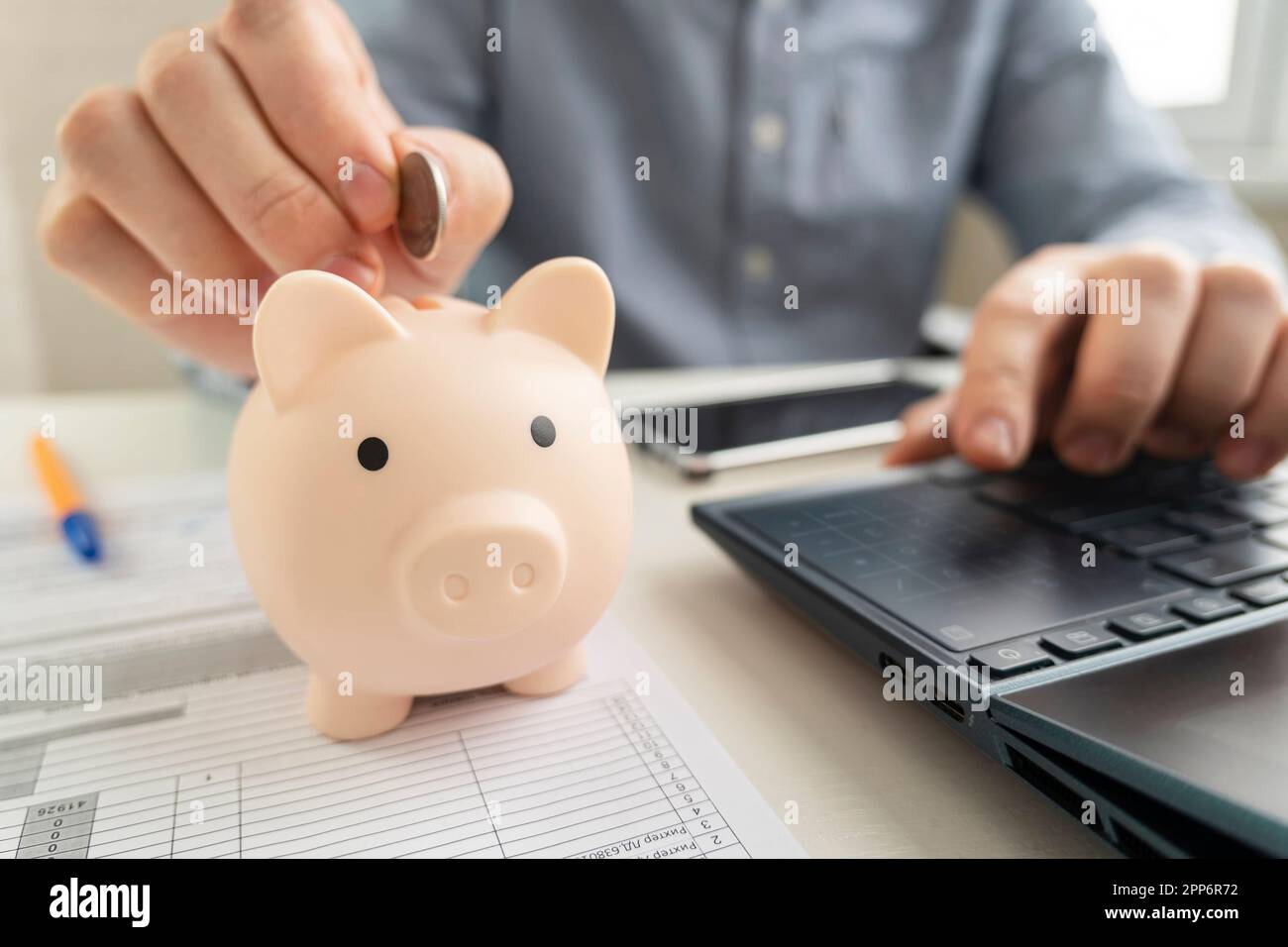 Saving money concept. Man hand putting coin drop into piggy bank and ...