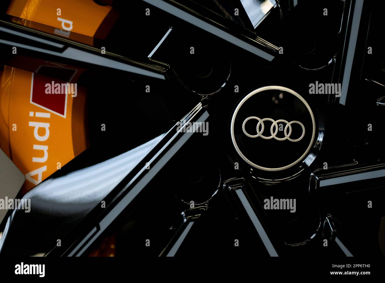 In this photo illustration, an Audi logo seen displayed on an electric ...