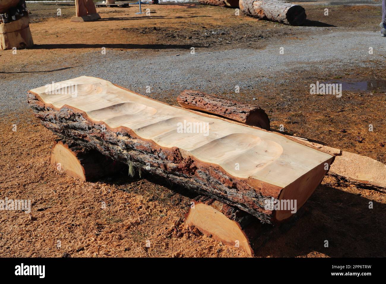 a bench made from a tree stump Stock Photo - Alamy