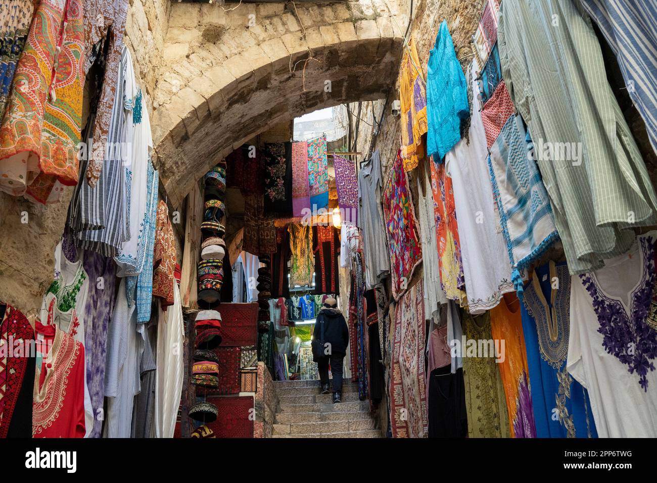 Colorful clothing and textile items for sale in an alley in the big ...