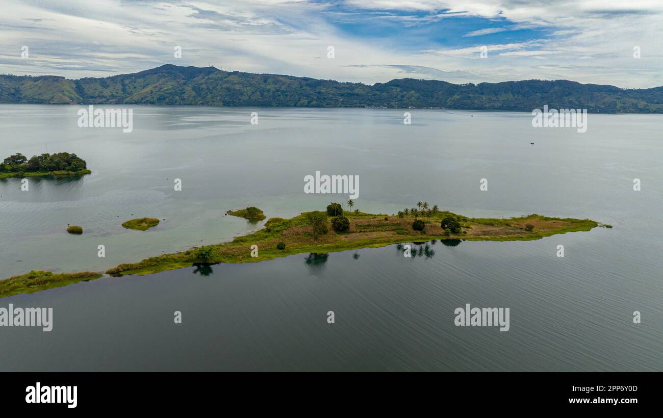 Top view of beautiful Lake Toba and an island with palm trees. Samosir ...