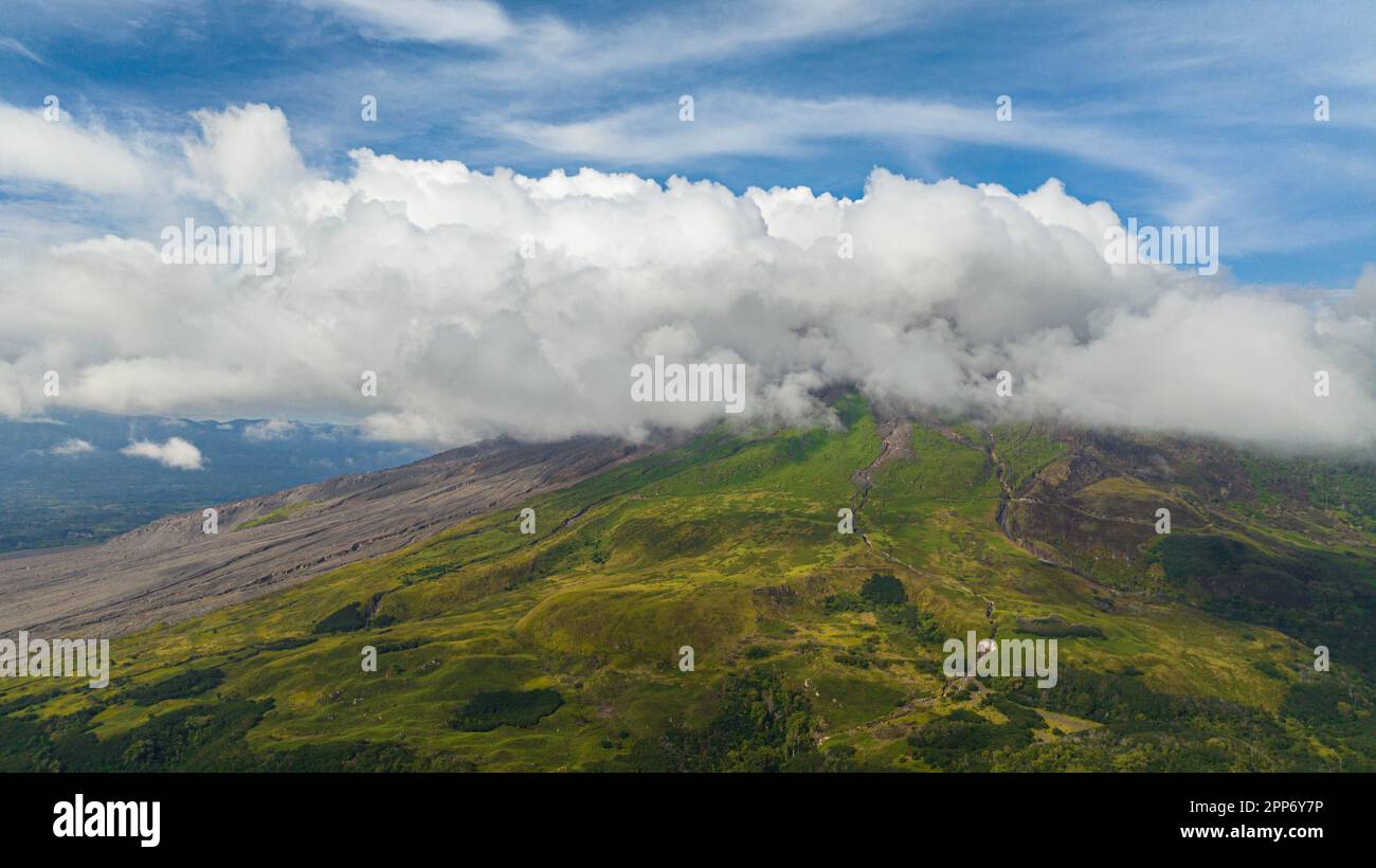 Aerial view of Sinabung volcano with slopes covered with clouds after ...
